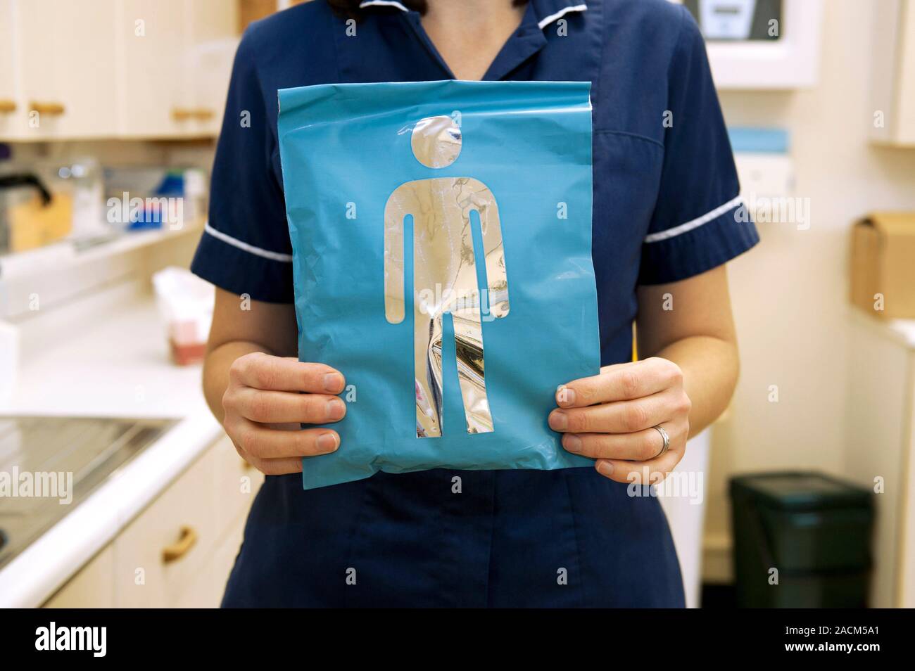 Nurse holds a male Chlamydia self-testing kit to detect Chlamydia ...