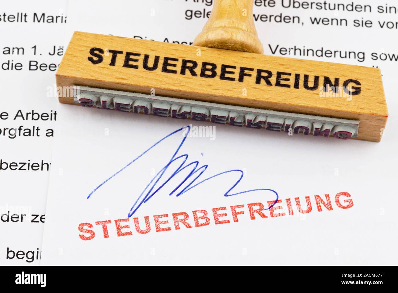 Wooden stamp on document: Tax exemption Stock Photo - Alamy