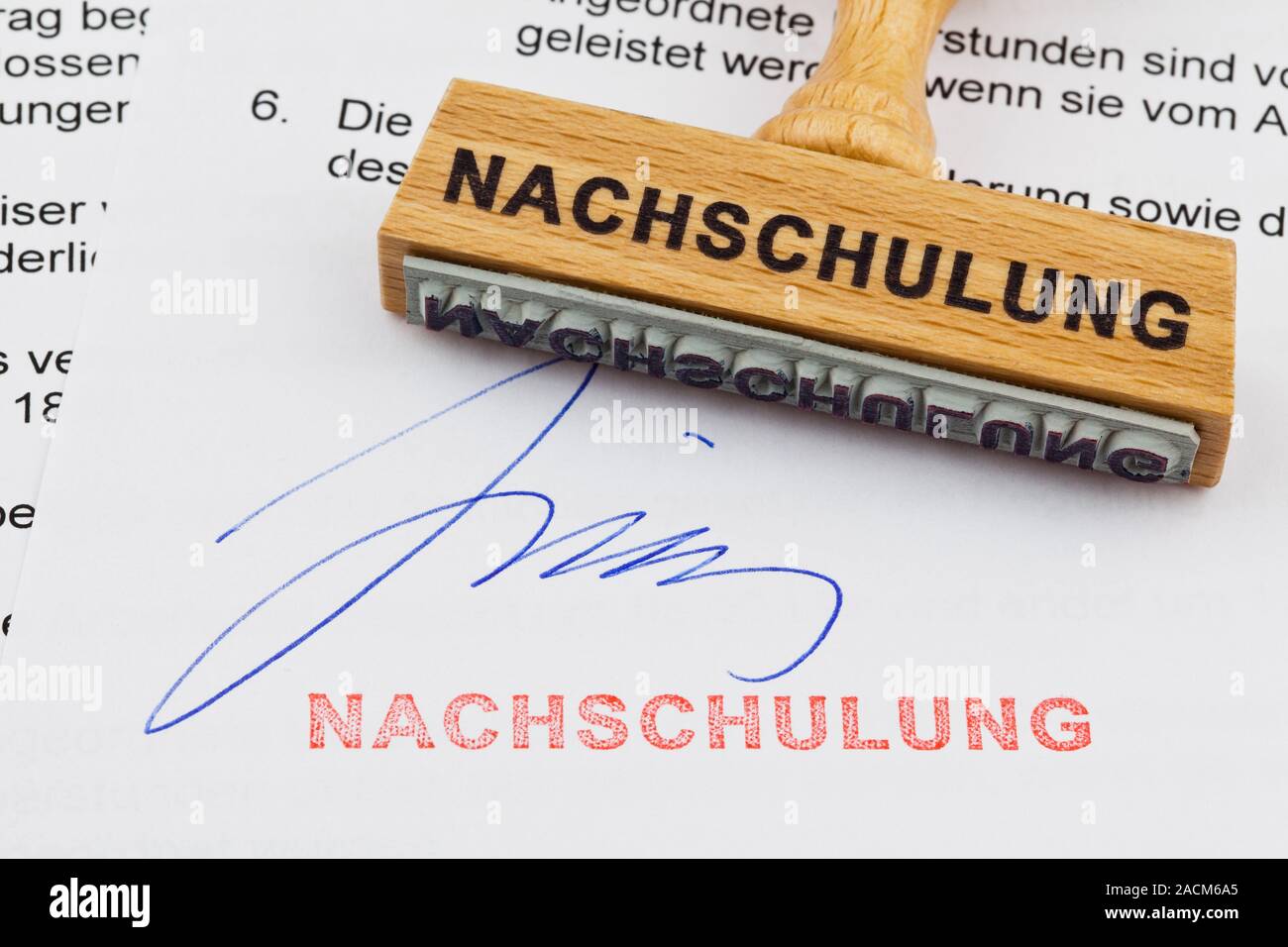 Wooden stamp on document: Follow-up training Stock Photo - Alamy