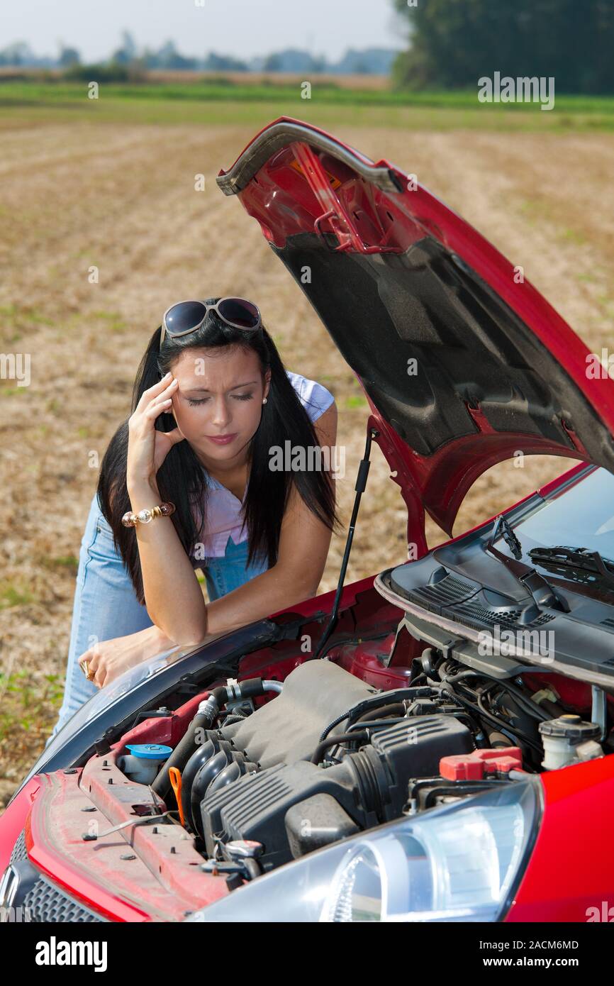 Woman breaks down in her car. engine failure Stock Photo - Alamy
