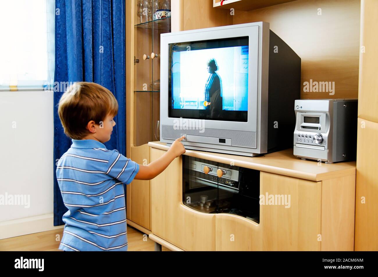 Small child watching television Stock Photo - Alamy