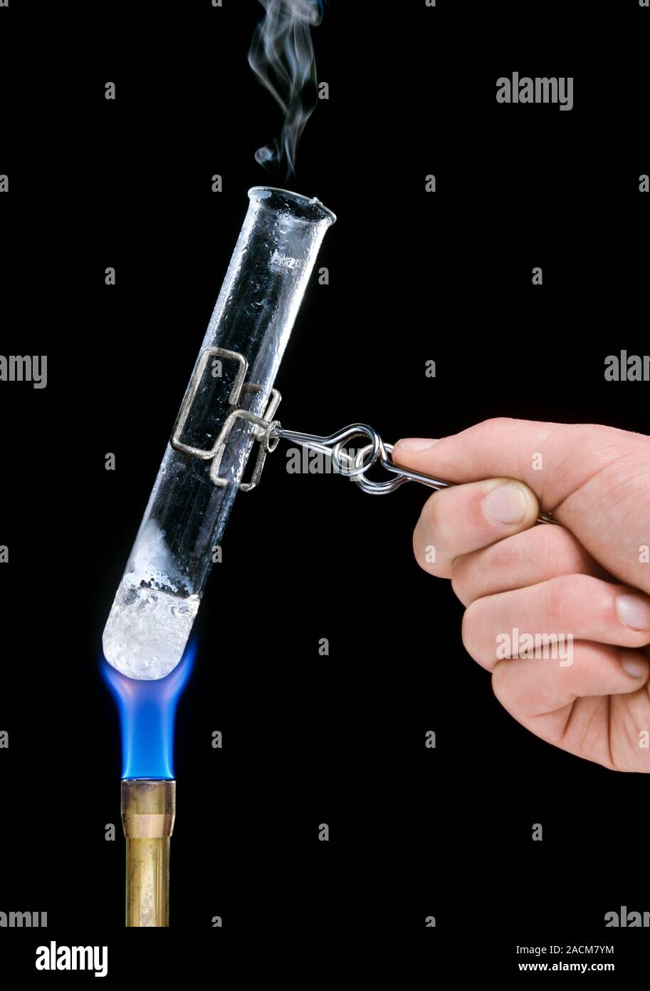 Boiling tube and bunsen burner. Boiling tube being held over a bunsen ...