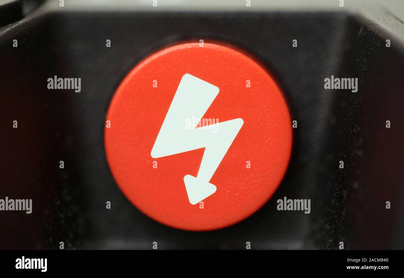 Symbol on a red button depicting electric discharge on the paddle of a ...