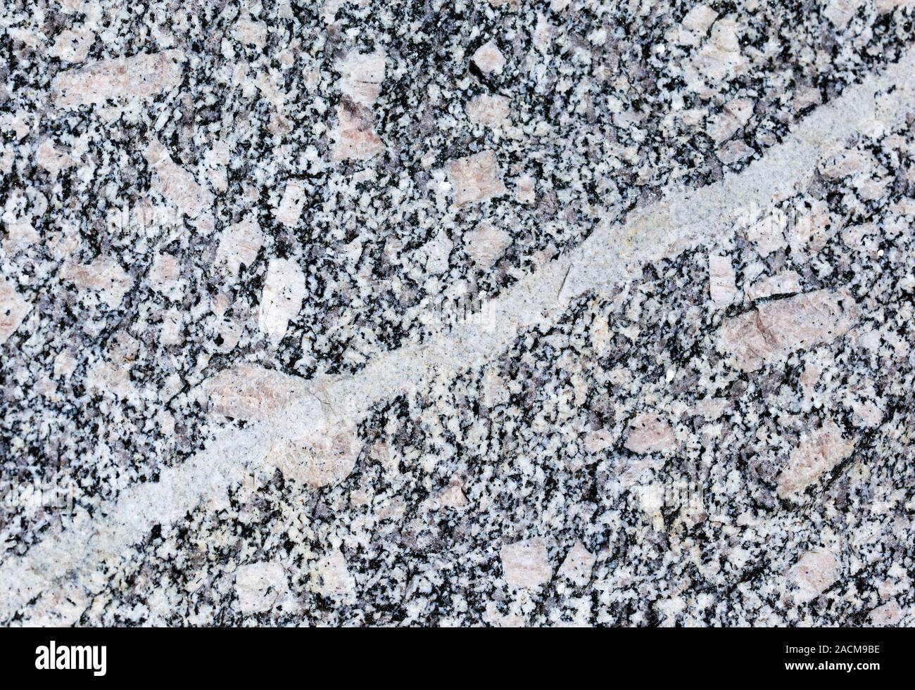 Quartz vein in granite. Close-up of a quartz vein (diagonal) running ...