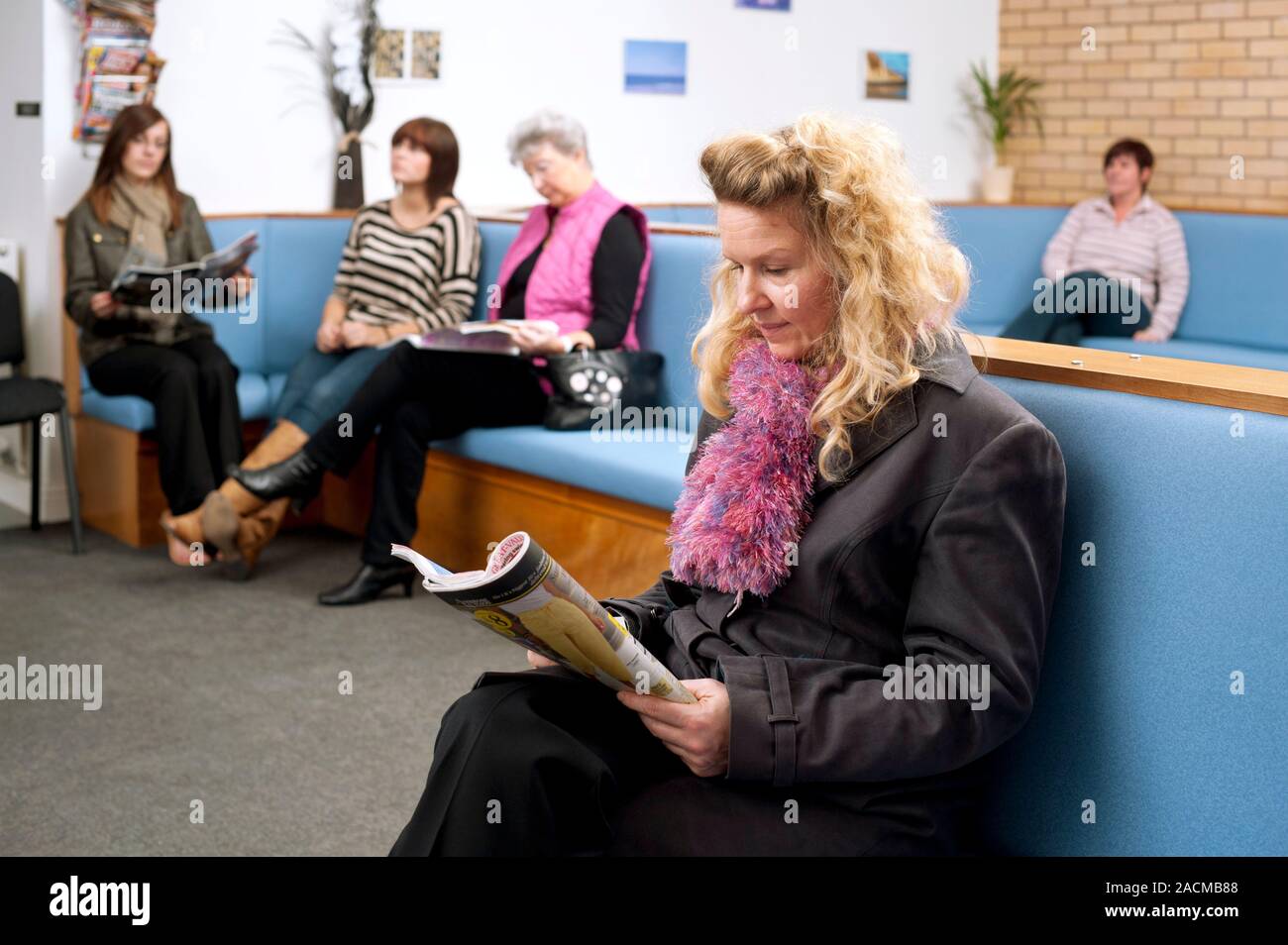 Waiting room. Woman reading a magazine in a waiting room Stock Photo ...