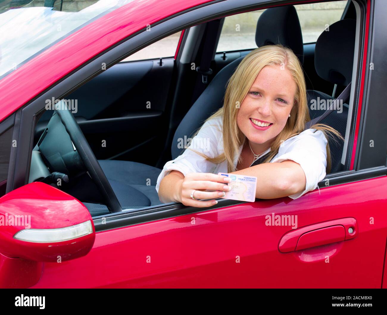 Young woman with driving licence Stock Photo - Alamy