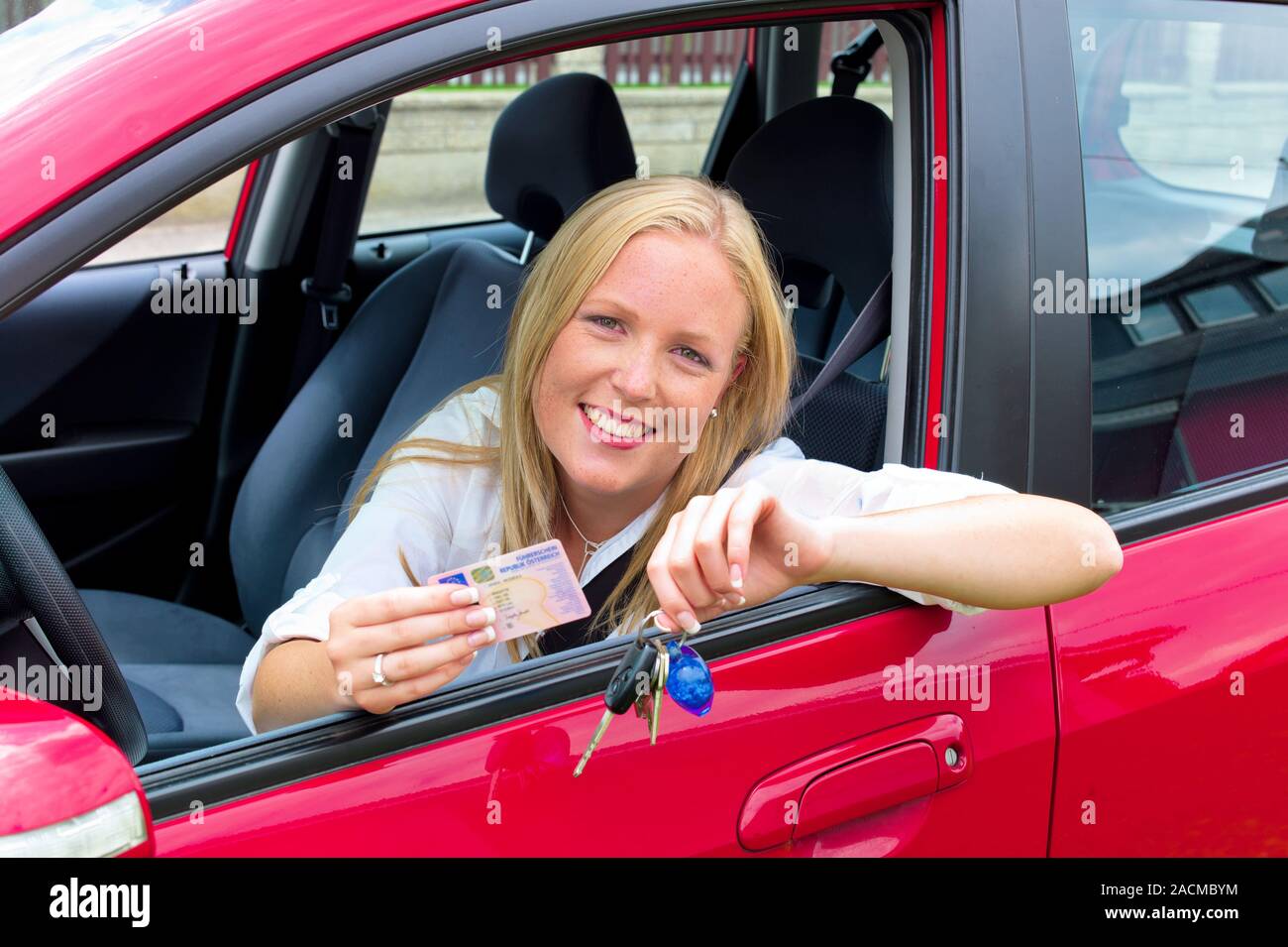 Young woman with driving licence Stock Photo - Alamy