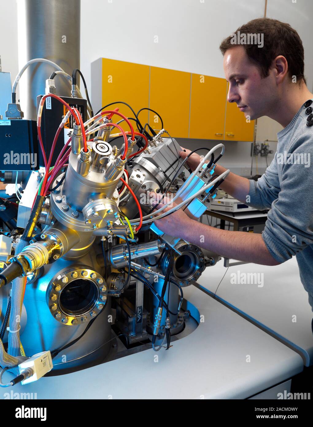 Mass spectrometer. Scientist setting up a time of flight secondary ion ...