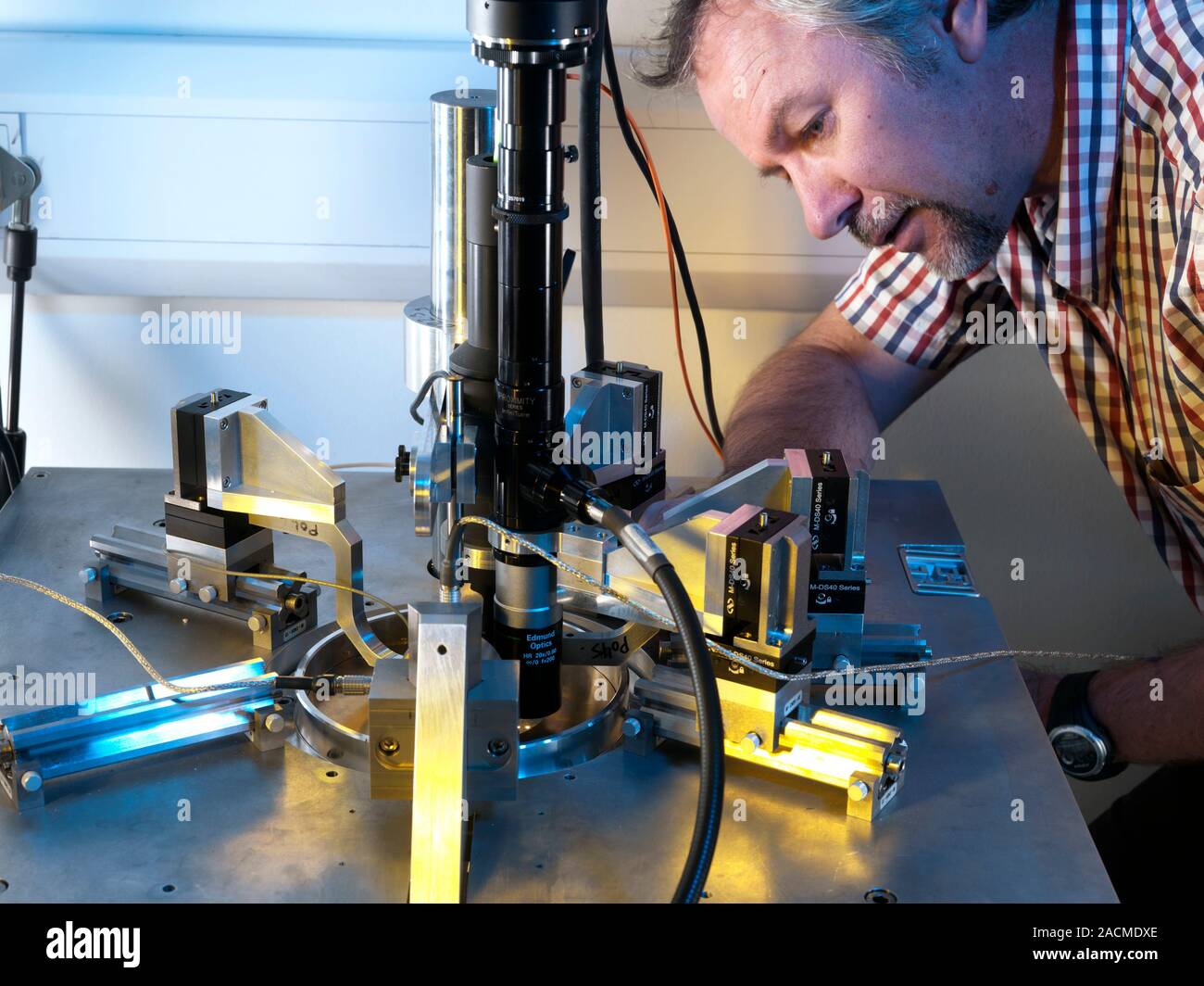 Pin on disc test. Researcher adjusting the apparatus during a pin on ...