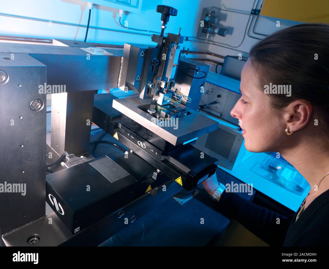 Hardness testing. Researcher using a scanning indentation mechanical ...