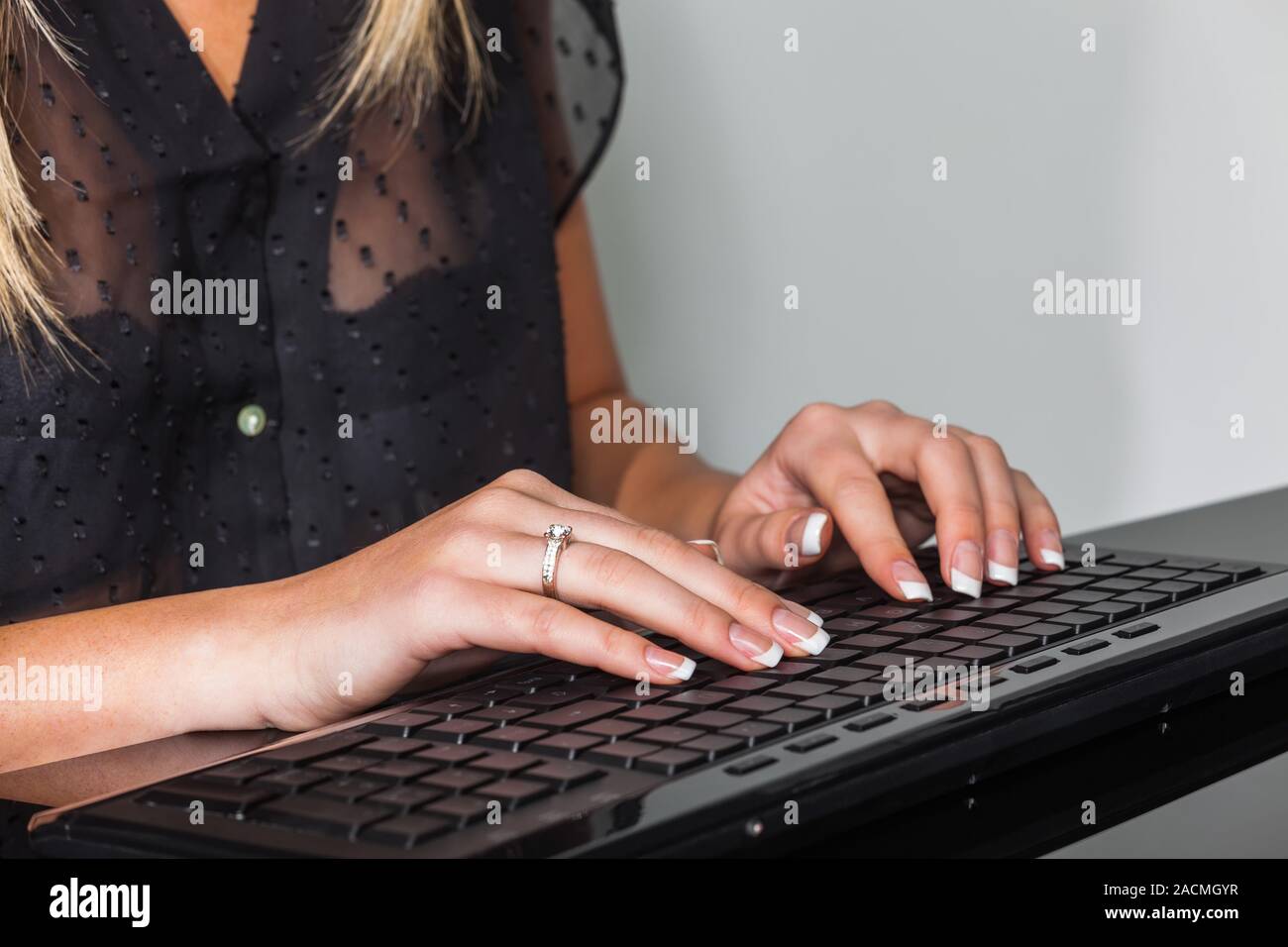 Woman with computer keyboard Stock Photo - Alamy
