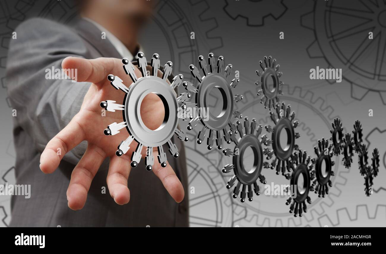 Businessman hand shows people cogs Stock Photo - Alamy
