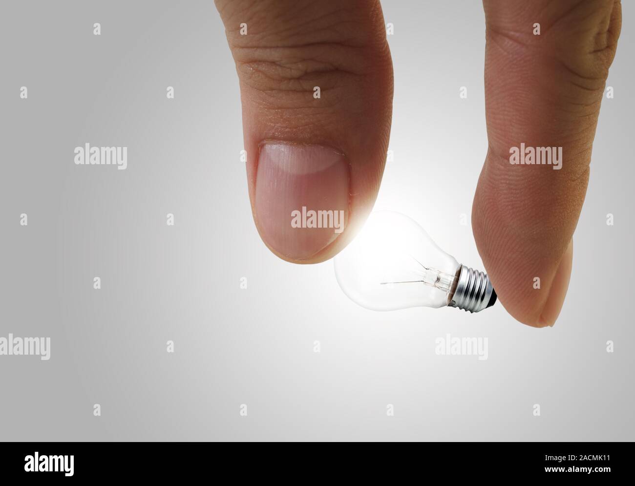fingers light bulb Stock Photo - Alamy