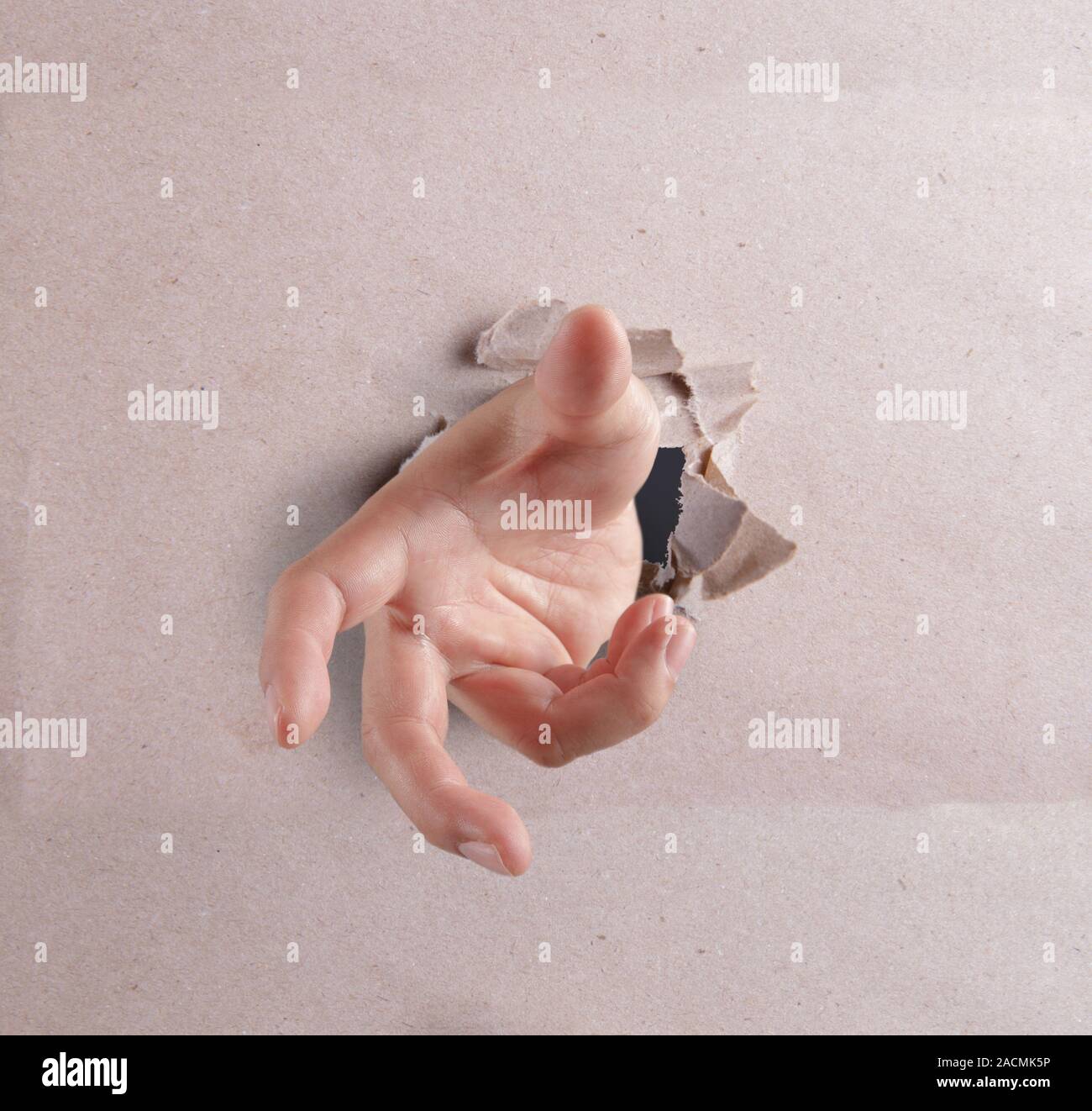 open hand breaking through textured Stock Photo - Alamy