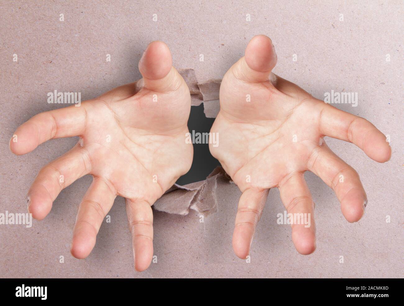 open hands breaking through textured Stock Photo - Alamy