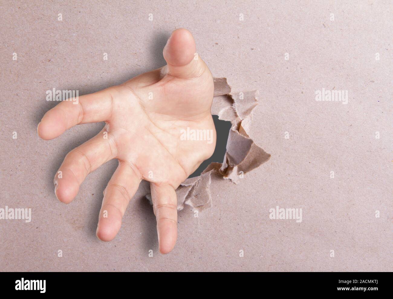 open hand breaking through textured Stock Photo - Alamy