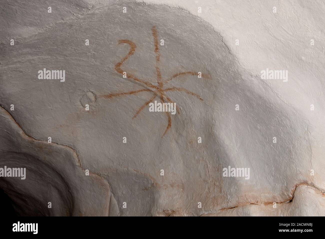Prehistoric cave paintings. Bronze Age markings drawn in red ochre on ...