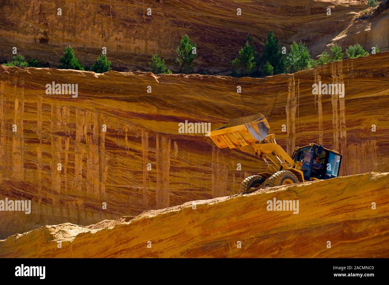 Ochre quarry. Digger at a yellow ochre quarry. Ochres are among the ...