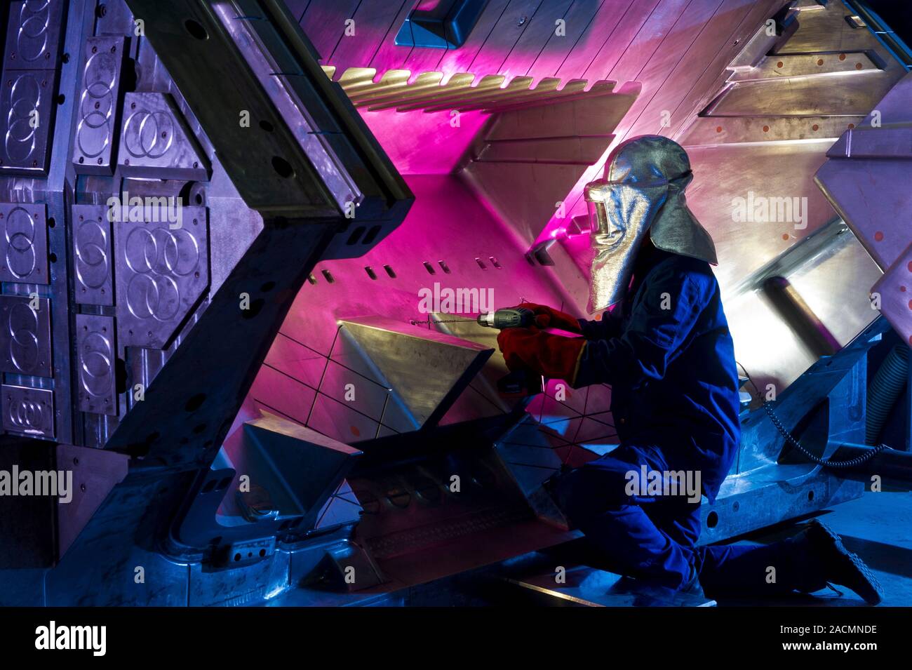 Swimming pool manufacturing. Worker at the Desjoyeaux swimming pool ...