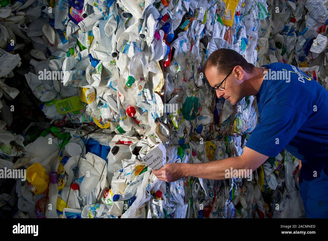 Swimming pool manufacturing. Factory worker next to a stack of ...