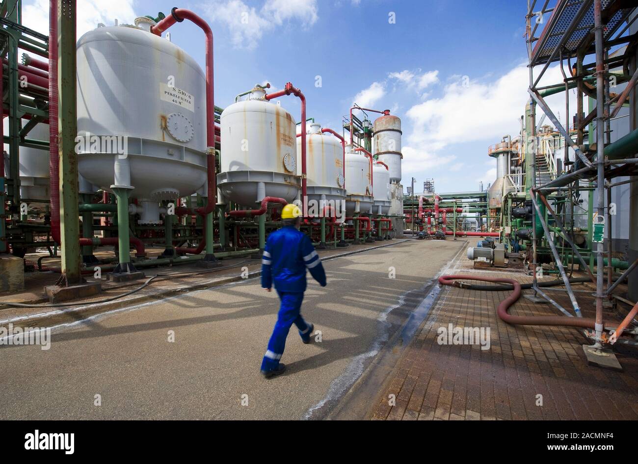 Industrial chlorine production. Chemical industry worker walking past ...
