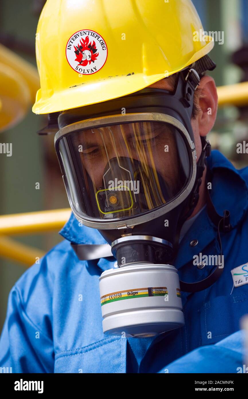 Industrial chlorine production. Industrial chemist wearing a respirator ...