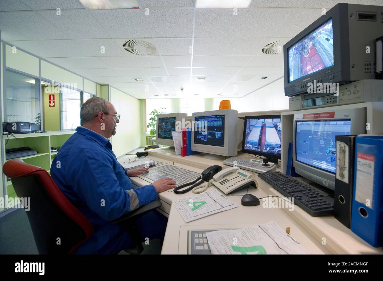 Chemical industry control room. Controller monitoring screens at a ...
