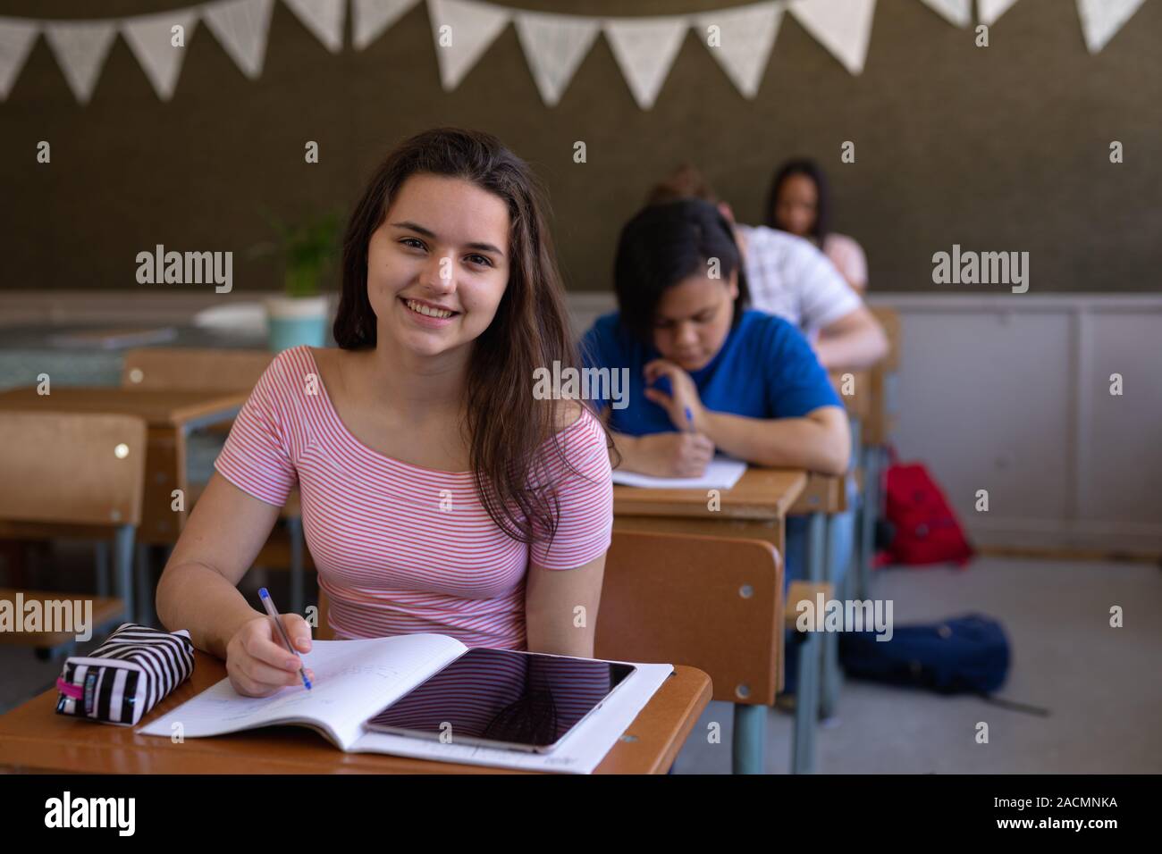 Teenagers in school classroom Stock Photo - Alamy