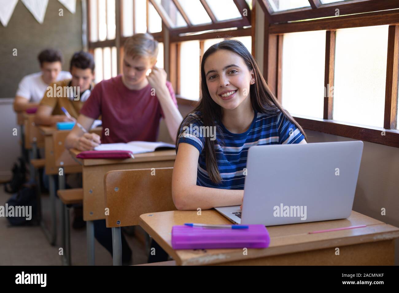 Teenagers in school classroom Stock Photo - Alamy