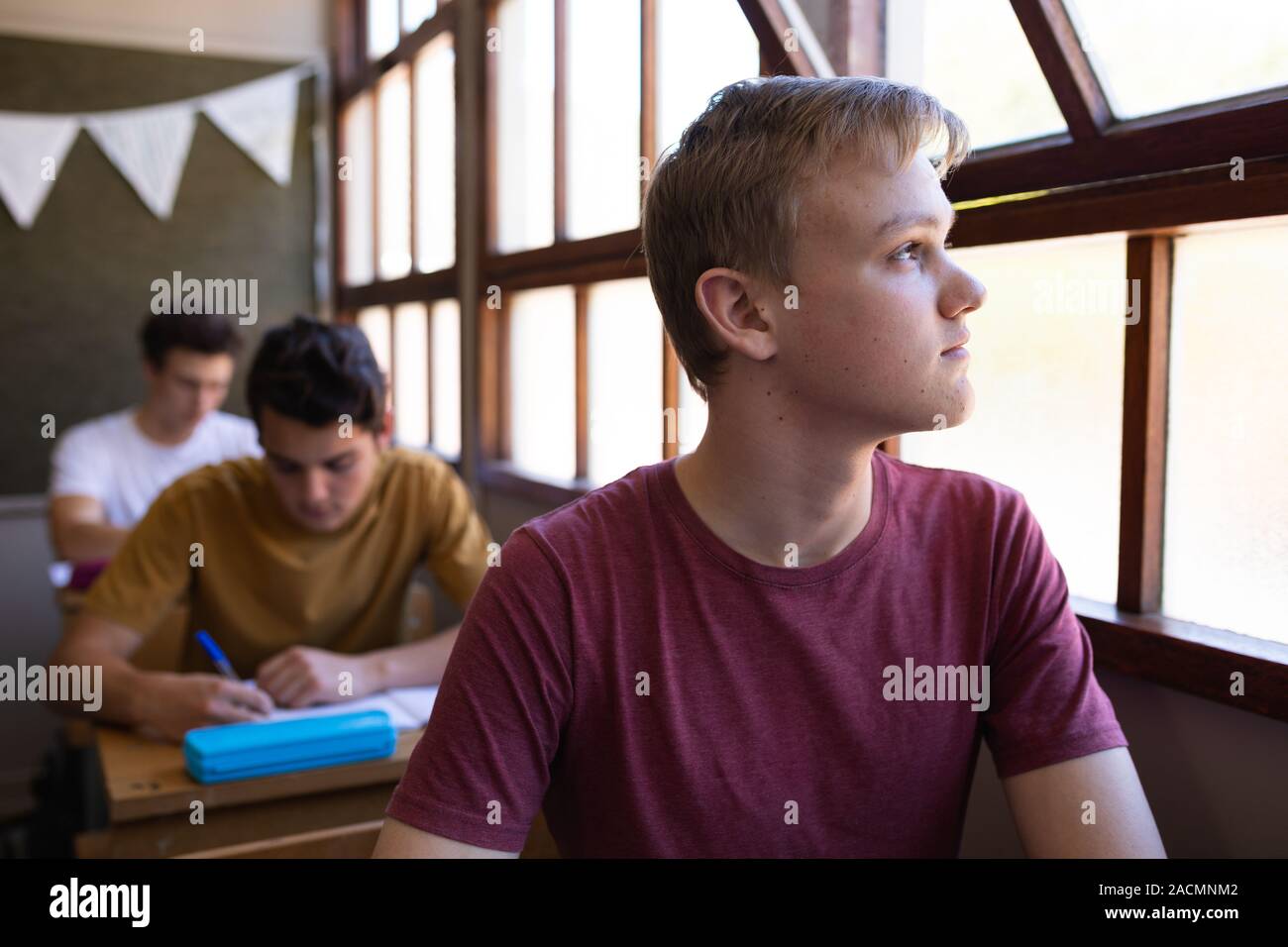 Teenagers in school classroom Stock Photo - Alamy