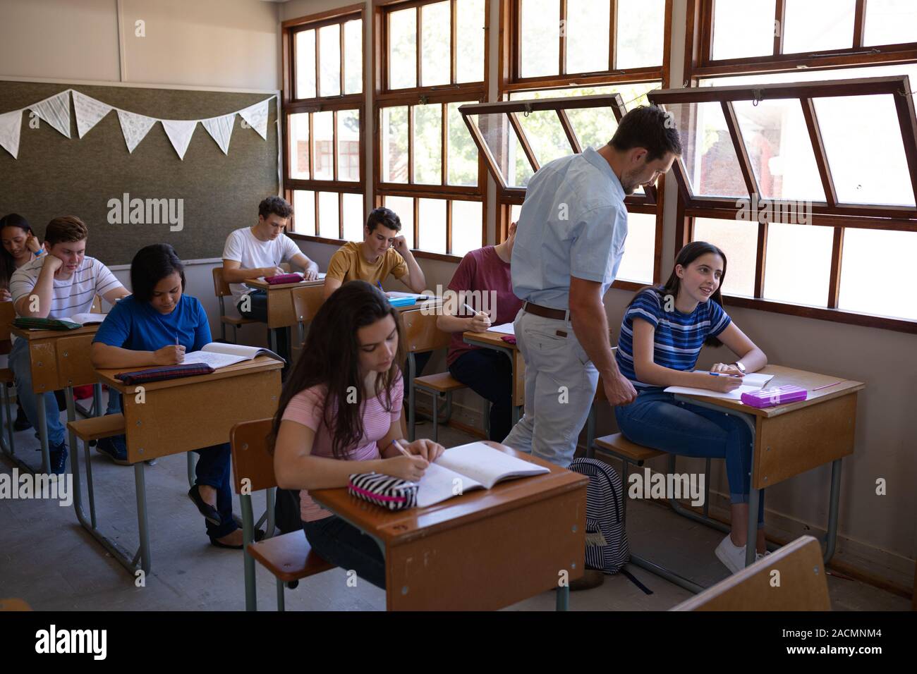 Teenagers in school classroom Stock Photo - Alamy