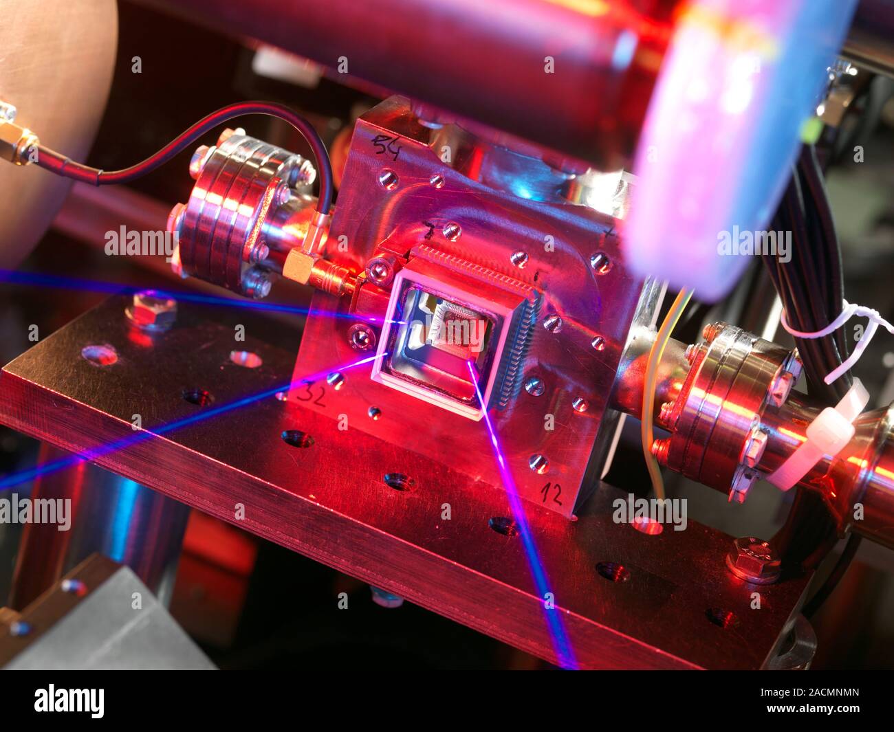 Ion microtrap. Ion trap (on microchip at centre) with lasers shining on ...