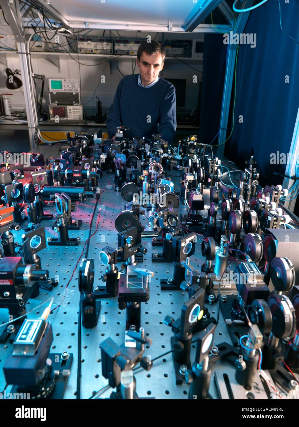 Caesium clock detection equipment. Scientist with an optical table ...