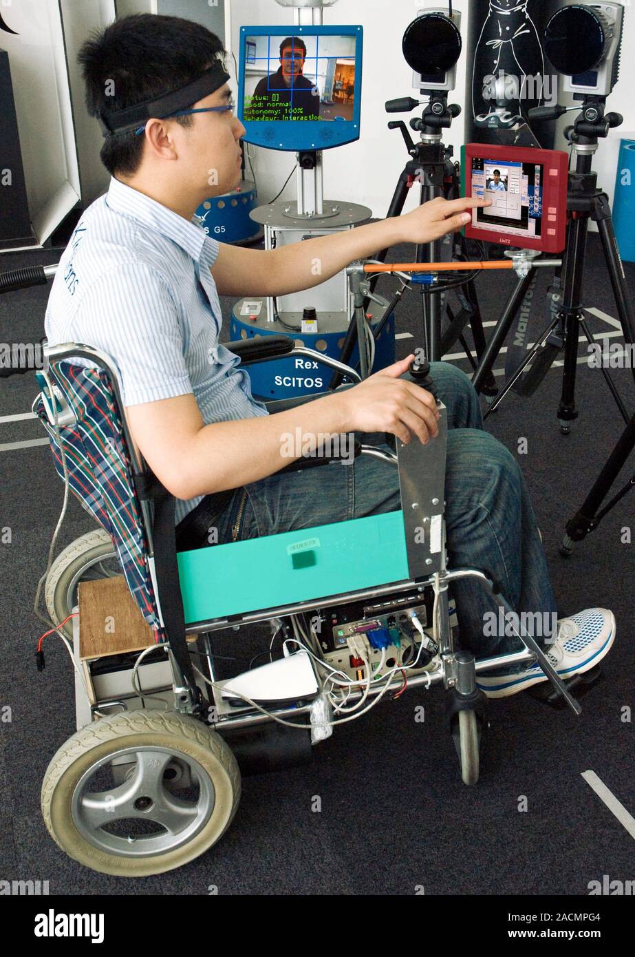 Robotic wheelchair interface research. Researcher testing a computer ...