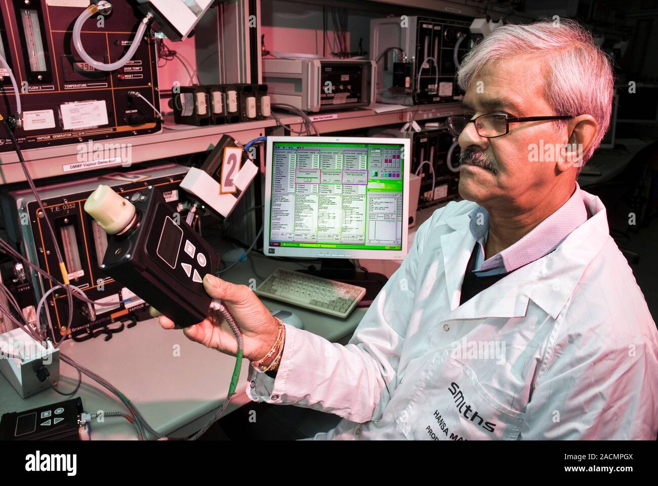 Portable chemical detector research. Technician testing a portable ...