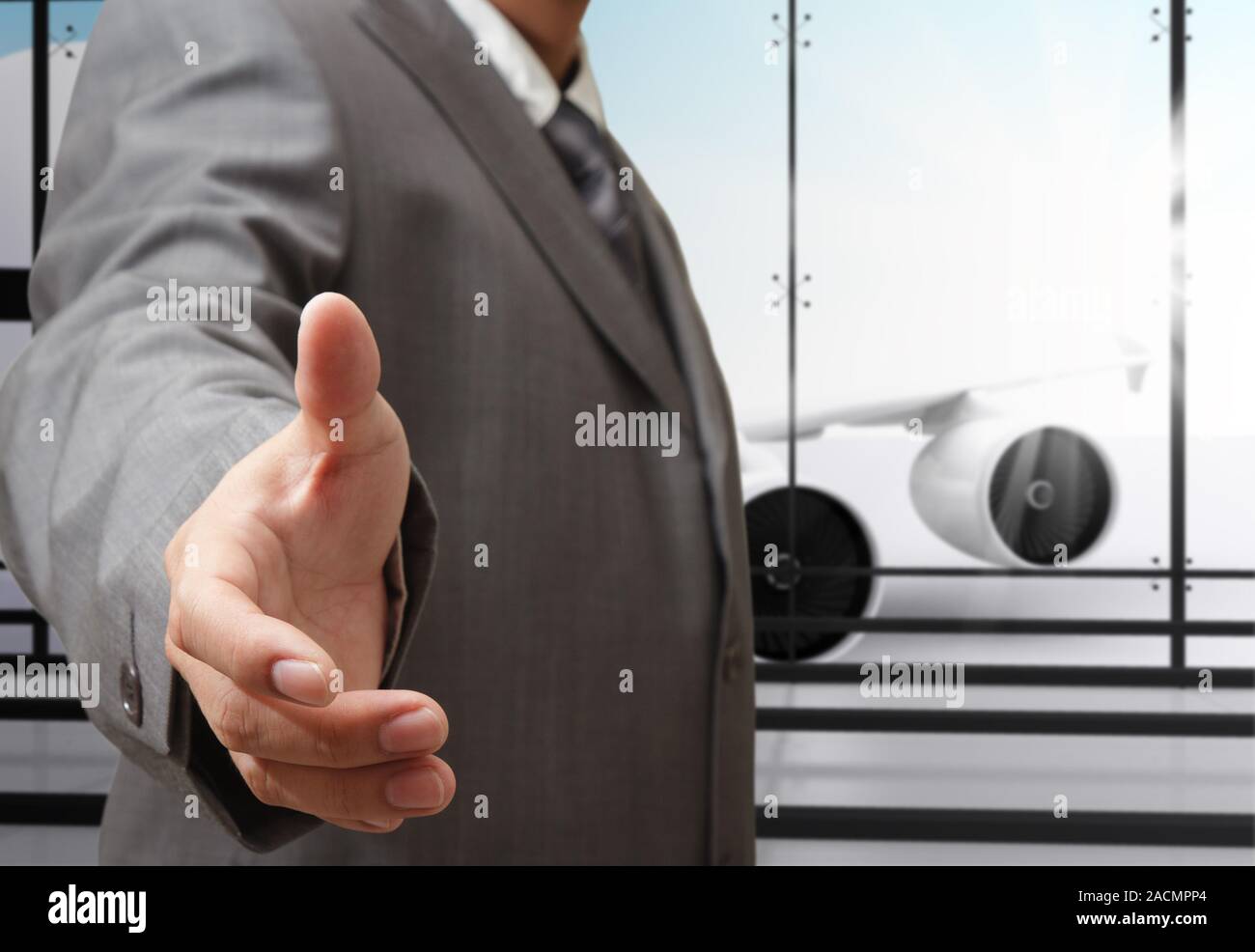 business man offers hand shake at the airport Stock Photo - Alamy