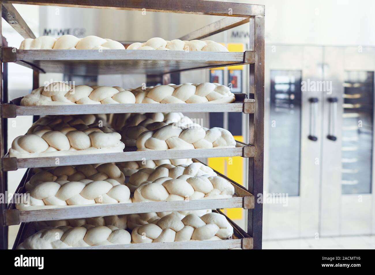 Fresh bread on trays before baking in the oven at the bakery Stock ...