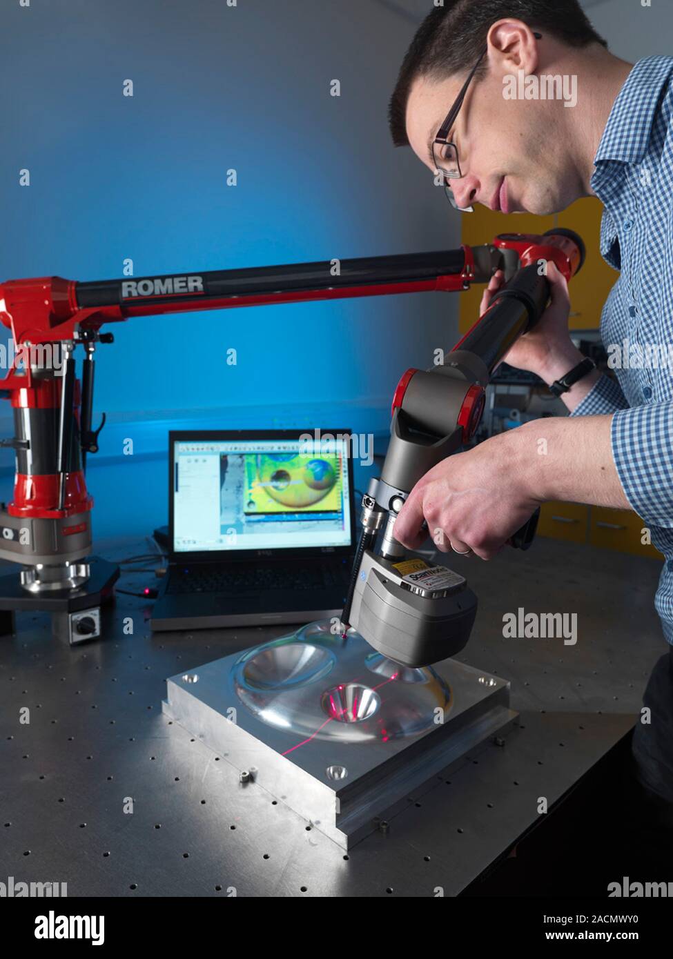 3D measurement machine use. Researcher using a coordinate measurement ...