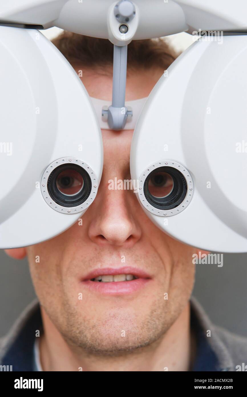 Eye test using refraction eye test equipment Stock Photo - Alamy