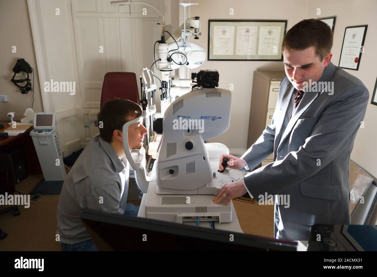 Patient having an eye test with a topcon retinal camera Stock Photo - Alamy