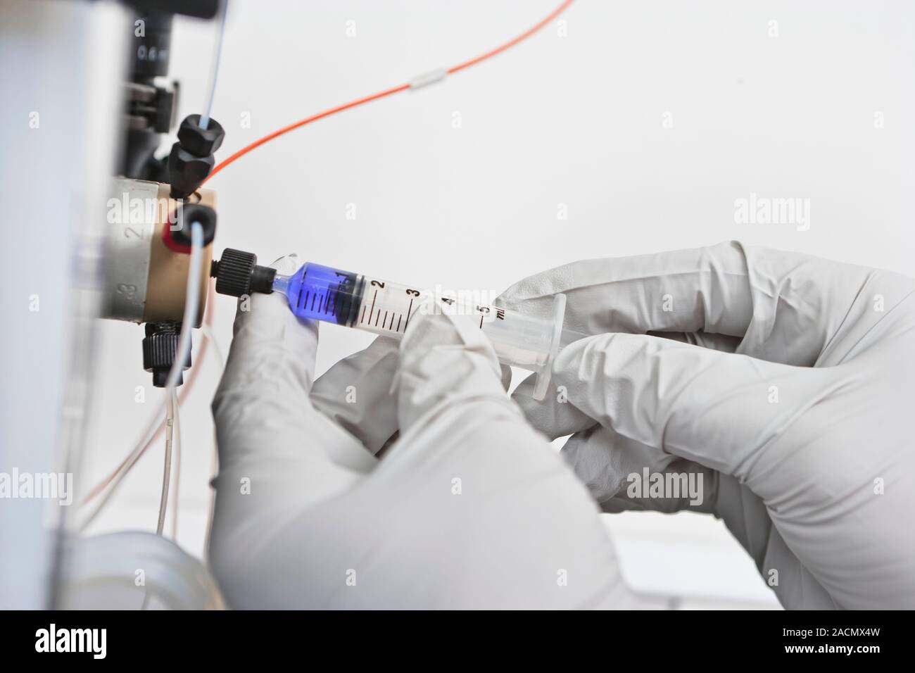 Fast protein liquid chromatography. Research assistant analysing ...
