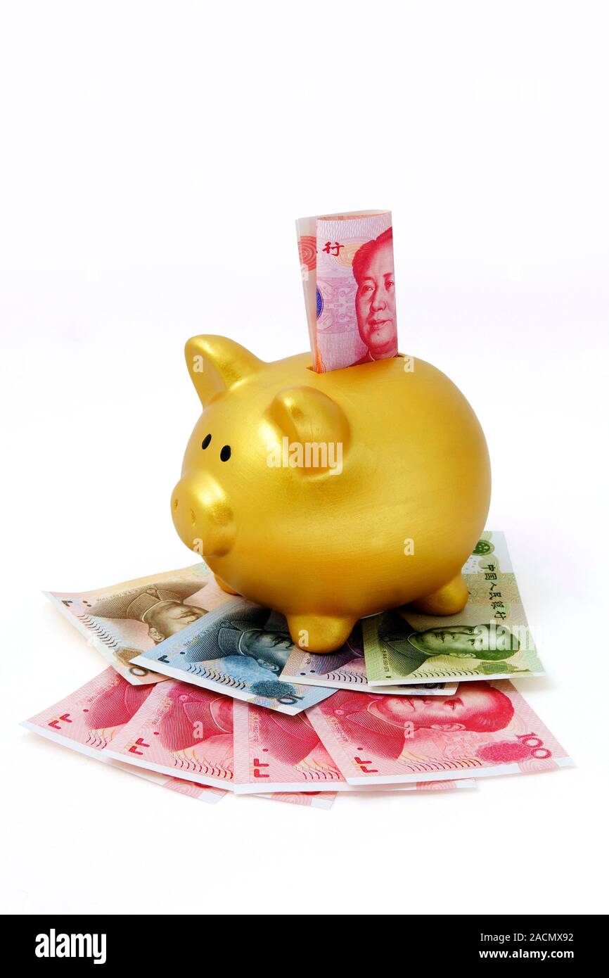 Chinese banknotes with piggy bank. The Chinese currency is the renminbi ...