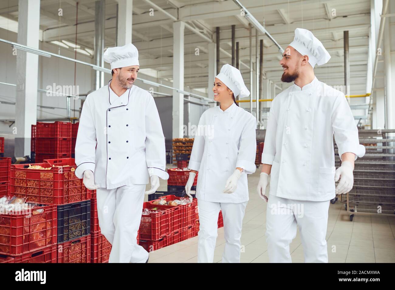 Bakers team goes in the workshop production of bread Stock Photo - Alamy