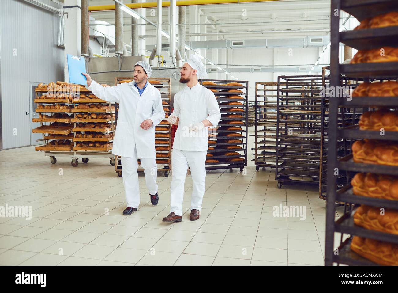 The technologist and baker speak in a bread factory Stock Photo - Alamy