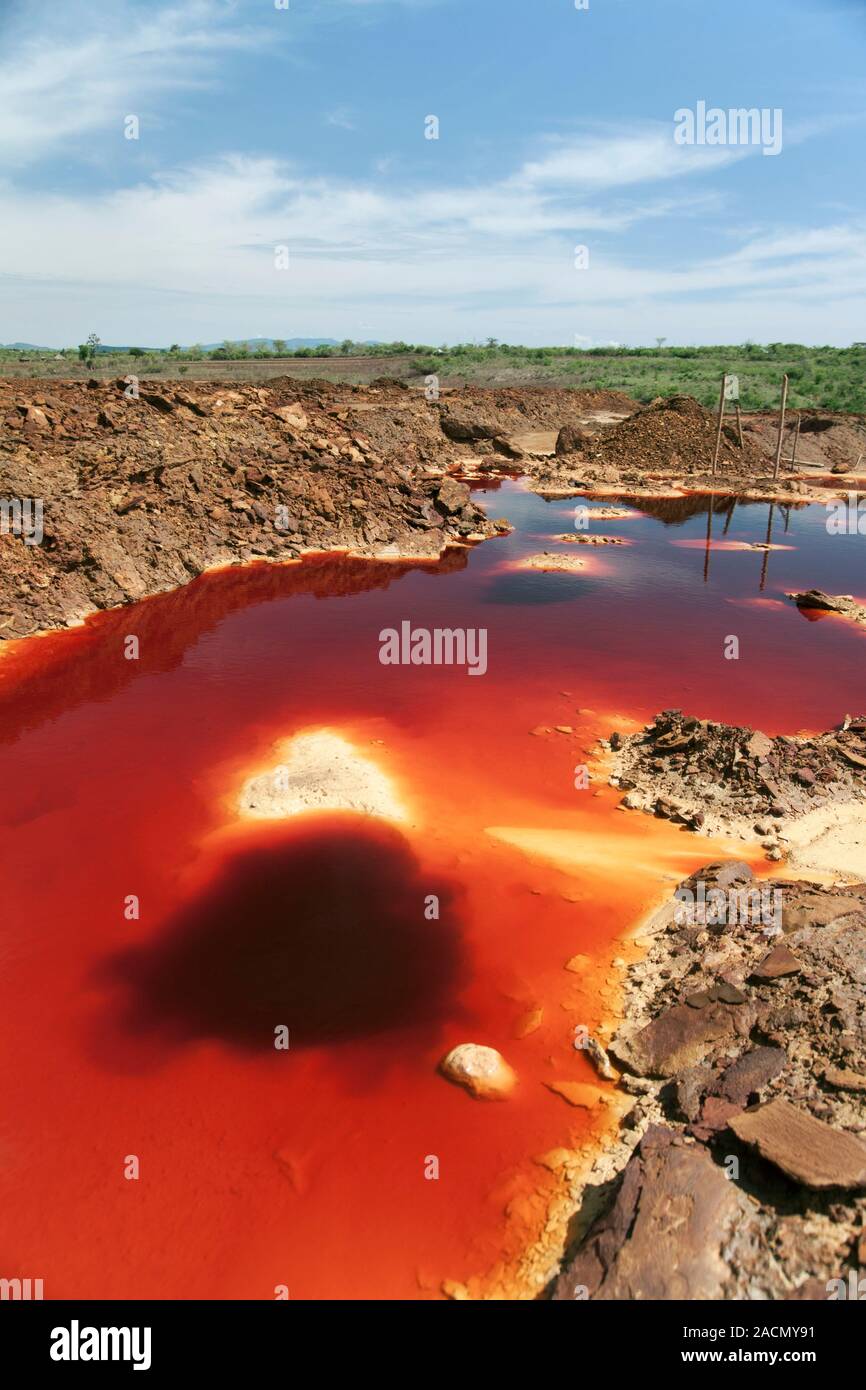 Acid mine drainage. Large pool of red coloured water caused by acid ...