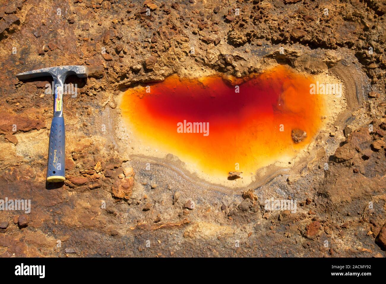Acid mine drainage. Pool of red coloured water caused by acid mine ...