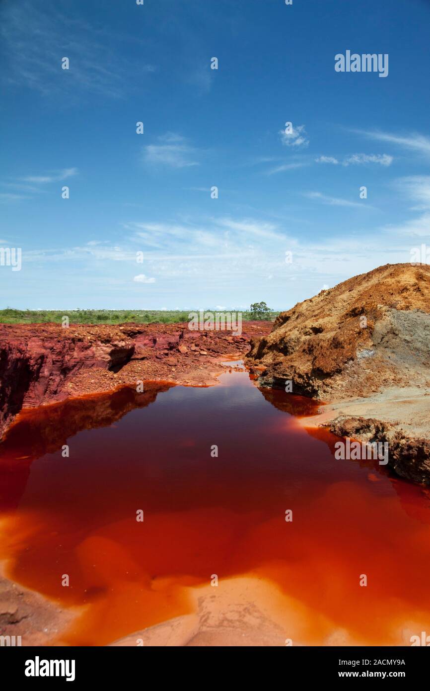 Acid mine drainage. Large pool of red coloured water caused by acid ...