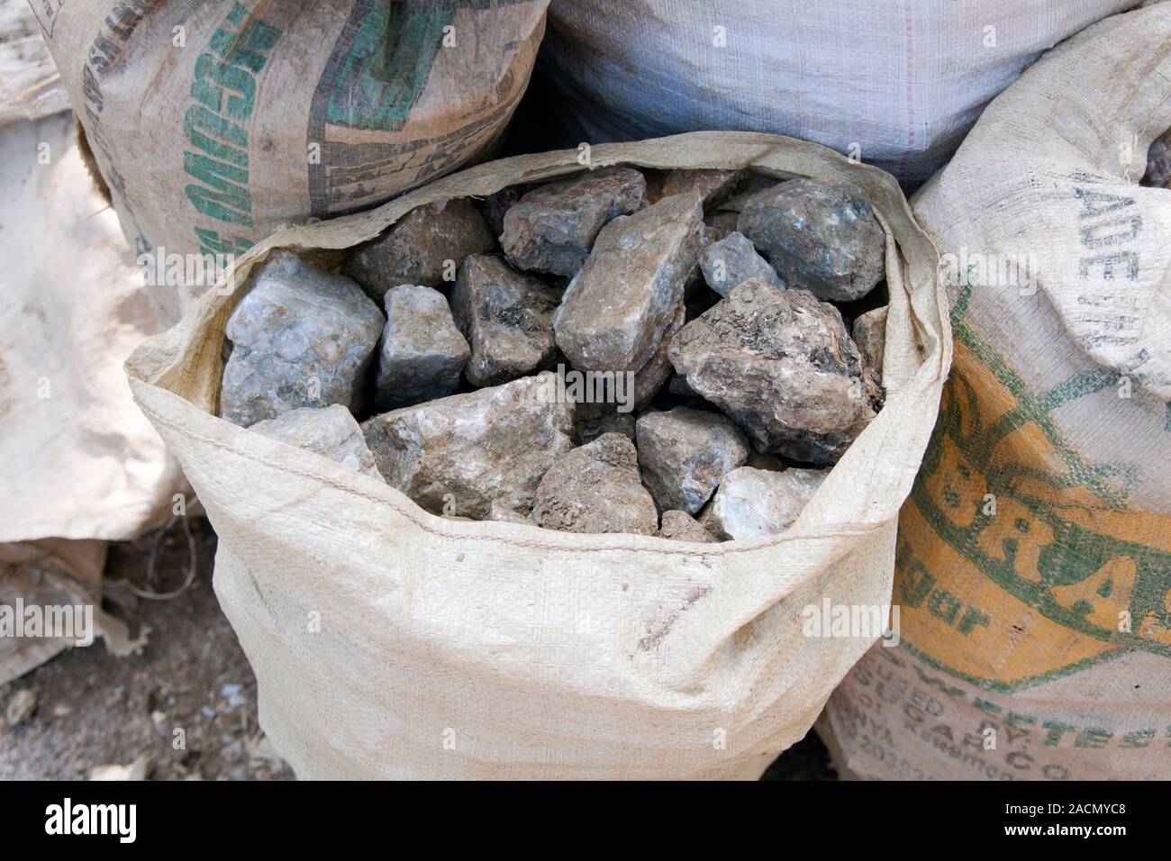 Artisanal mining. Bags of stones ready for processing. The stones will ...