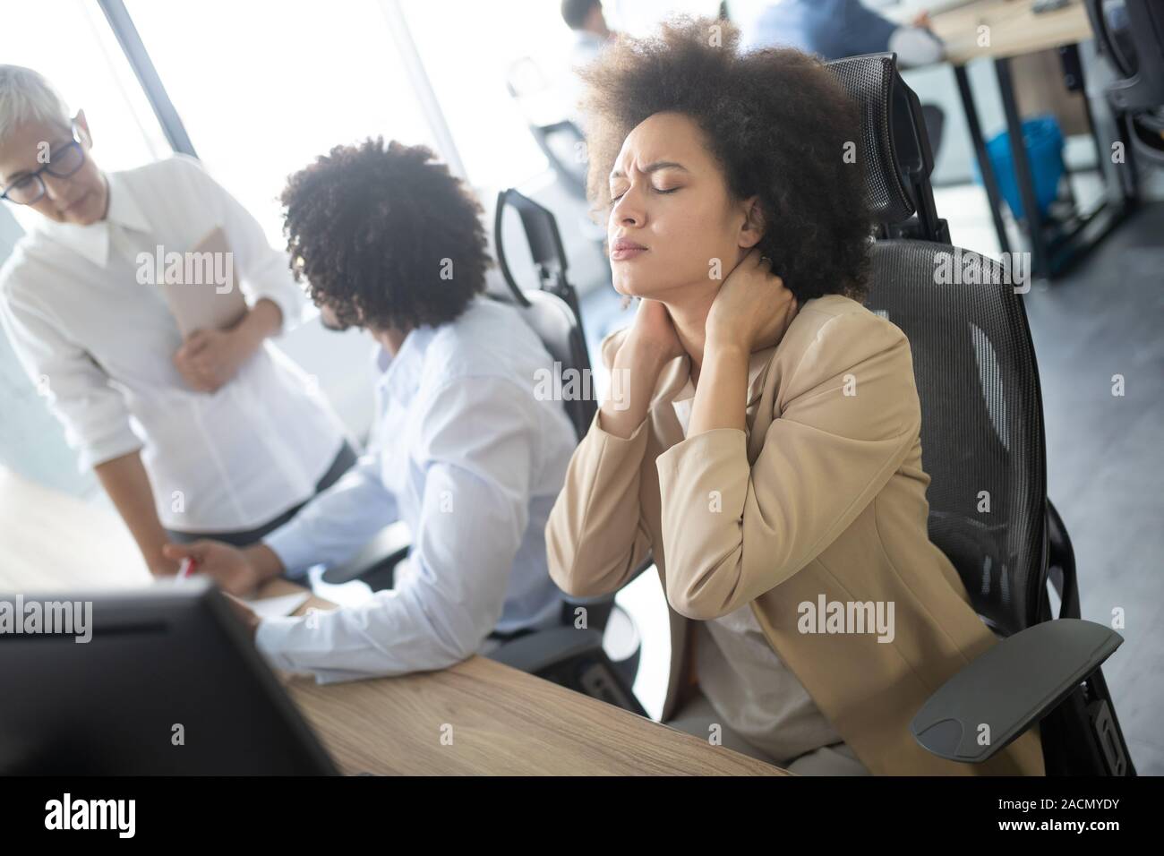 Young african business woman having stress and headache in the office ...