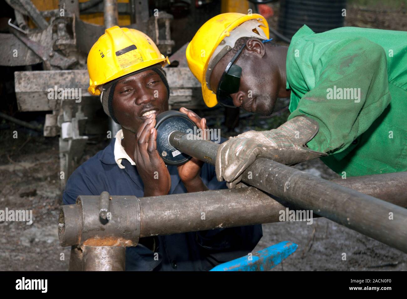 Mineral exploration drilling. Worker orientating the core in a drill ...